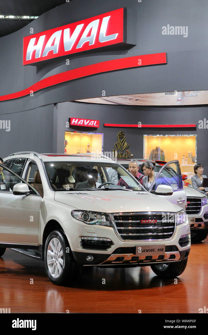 --FILE--Visitors try out or look at a Haval H8 SUV of Great Wall Motor ...