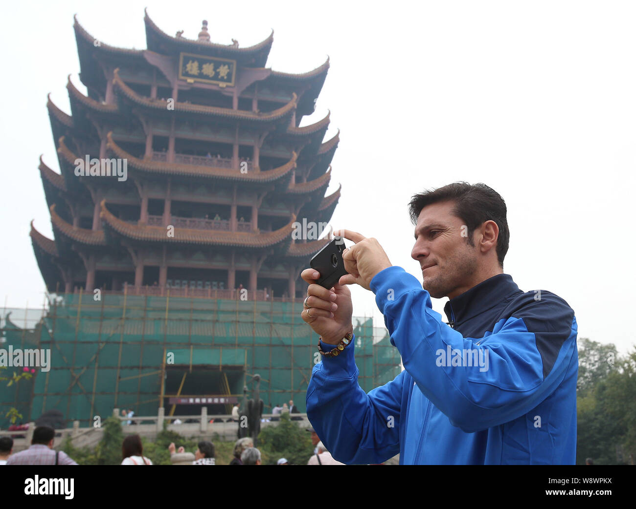 Argentine football star Javier Zanetti takes photos during his visit to ...