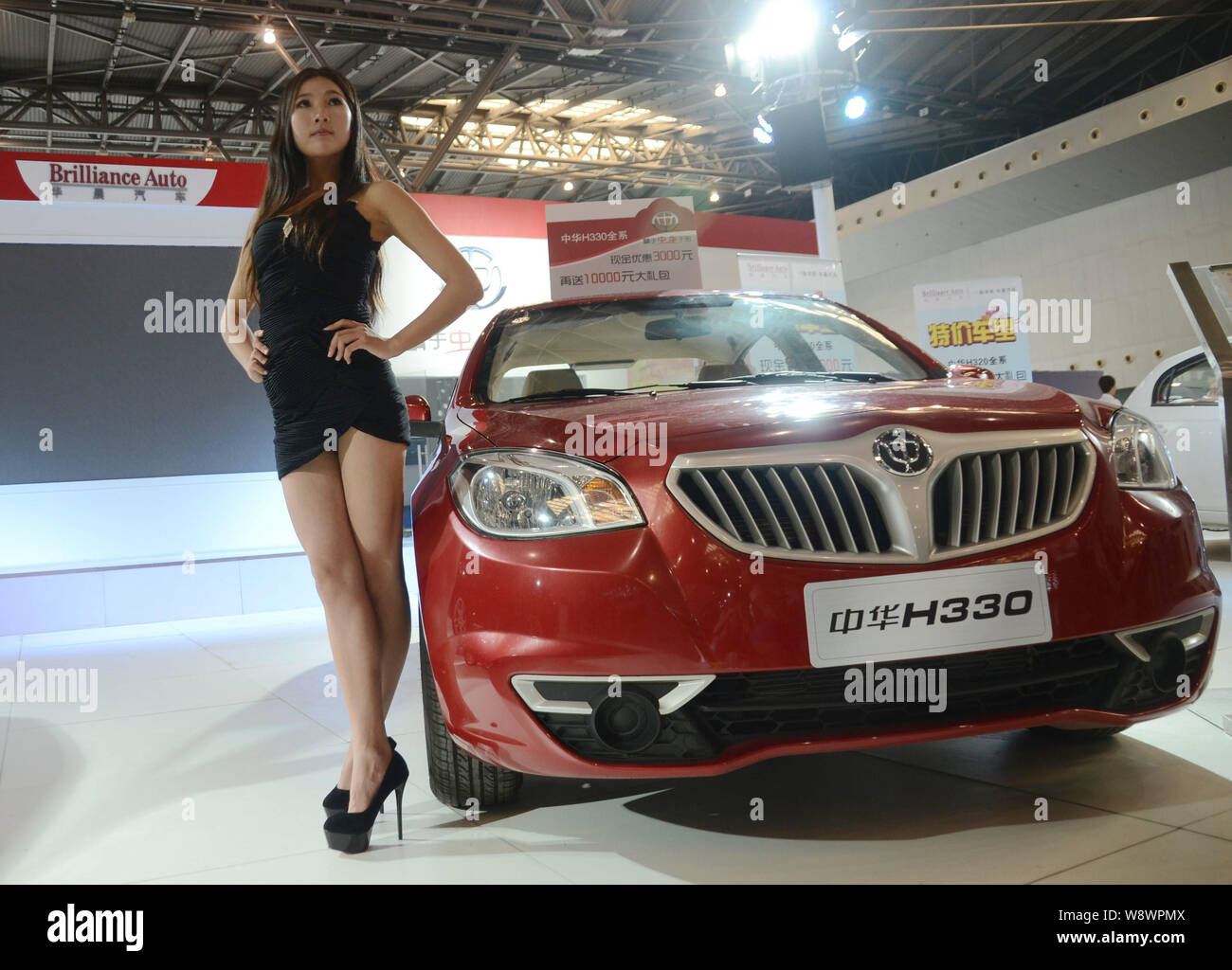 --FILE--A model poses with a Brilliance H330 of Brilliance Automotive ...