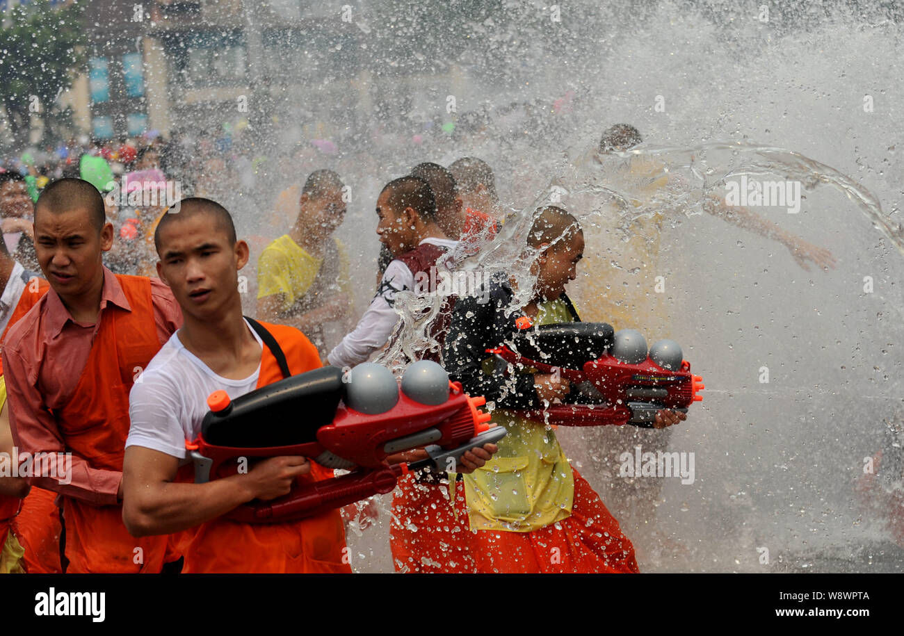 Local Chinese monks splash water with water guns to celebrate the New ...