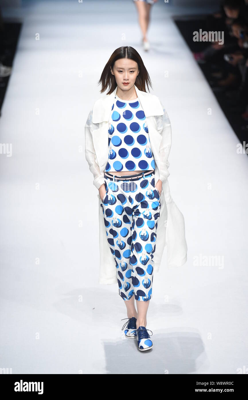 A model displays a new creation by designer Huang Liyong at the ...