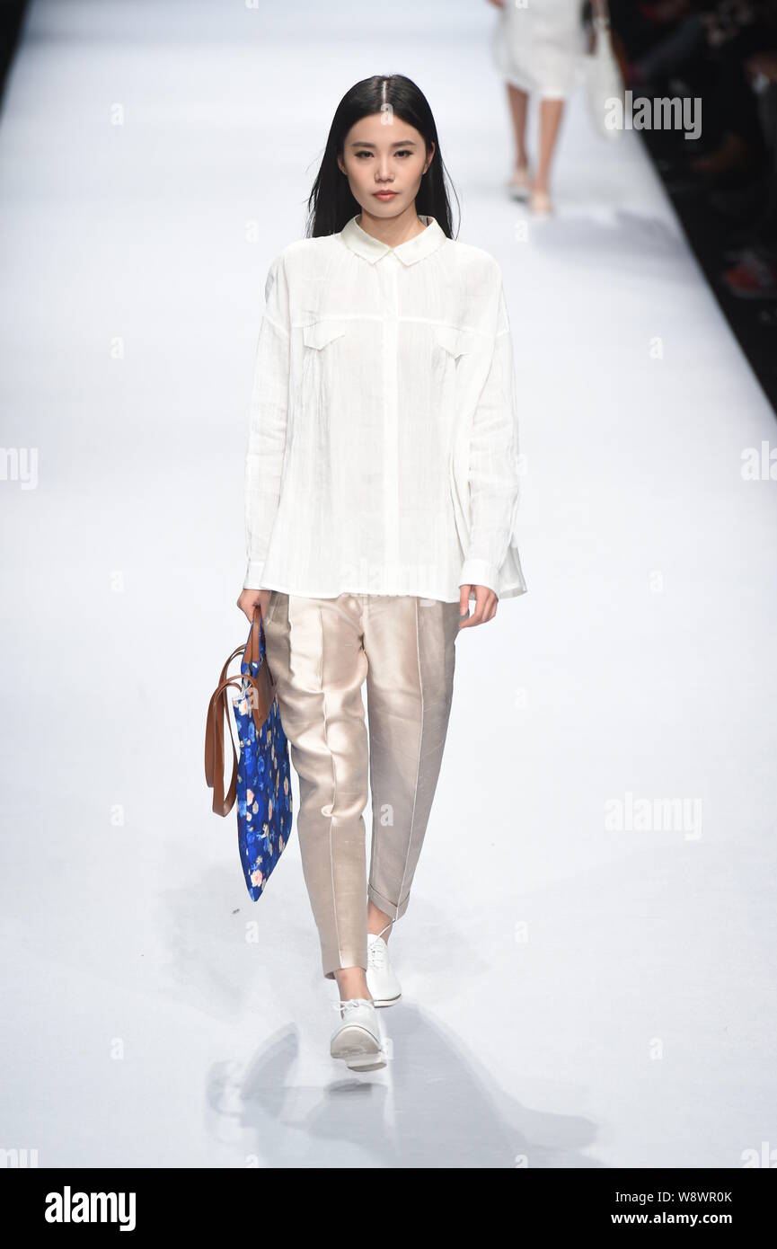 A model displays a new creation by designer Huang Liyong at the ...