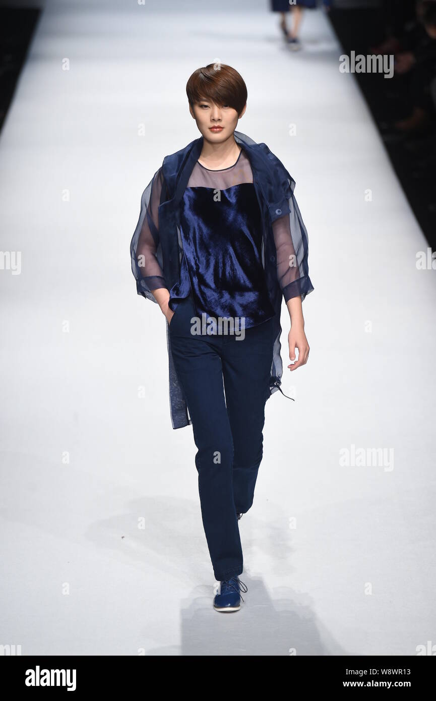 A model displays a new creation by designer Huang Liyong at the ...