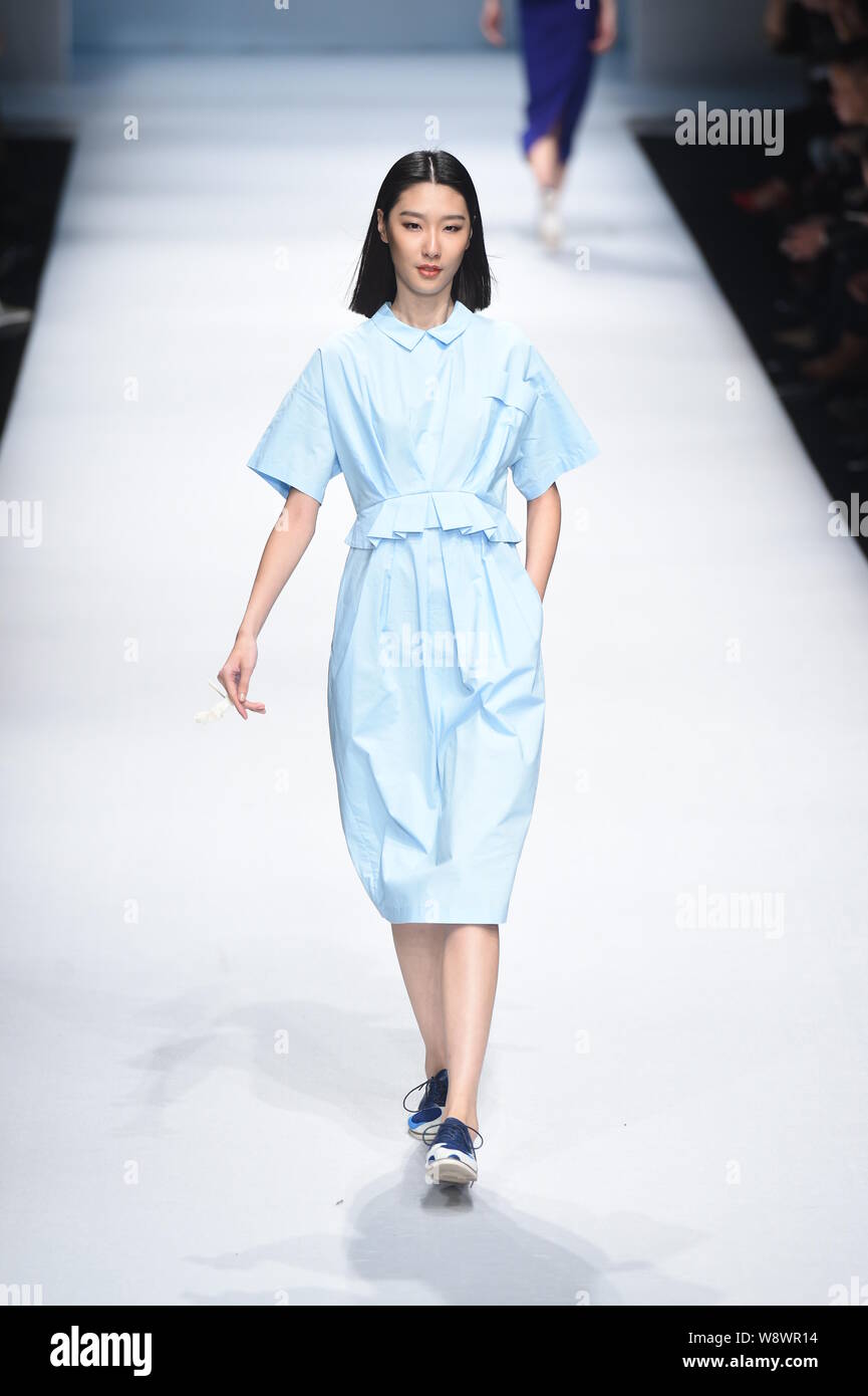 A model displays a new creation by designer Huang Liyong at the ...