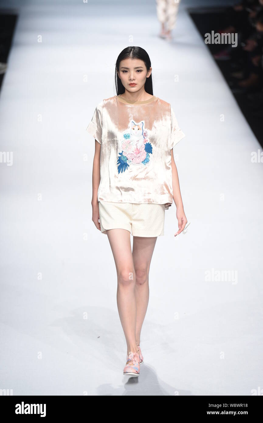 A model displays a new creation by designer Huang Liyong at the ...
