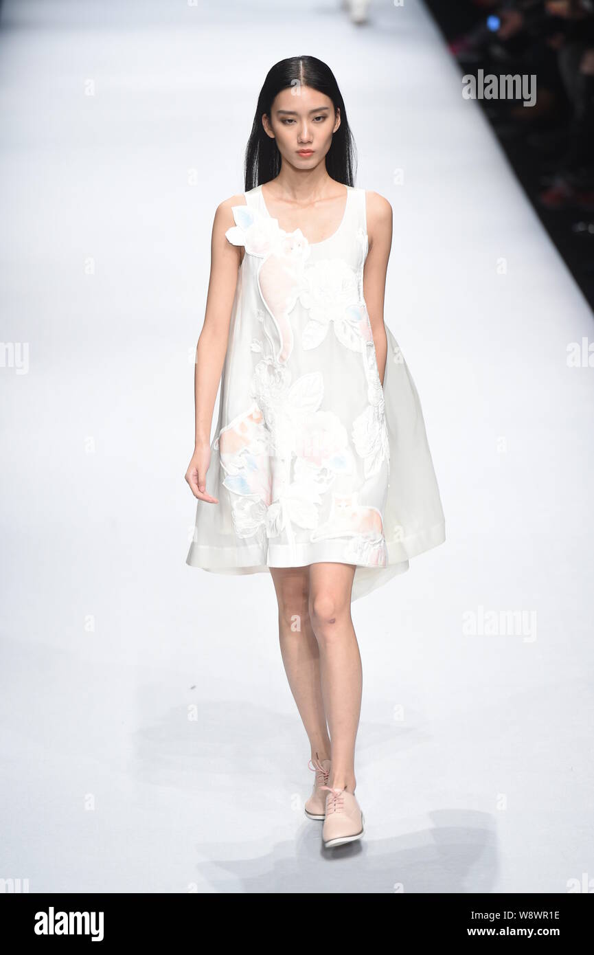 A model displays a new creation by designer Huang Liyong at the ...