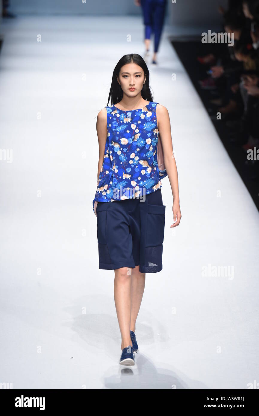 A model displays a new creation by designer Huang Liyong at the ...