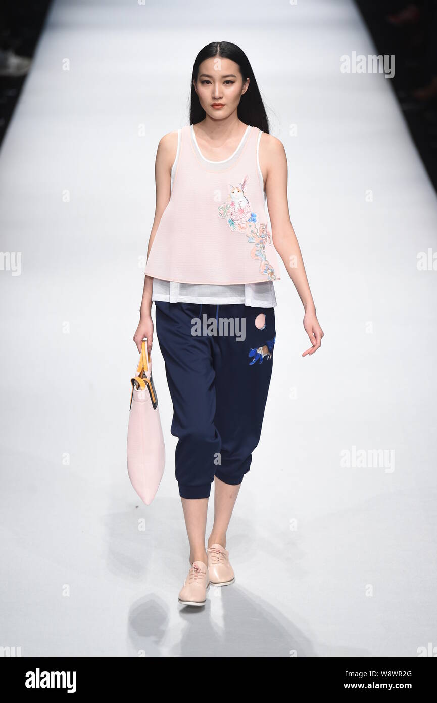 A model displays a new creation by designer Huang Liyong at the ...
