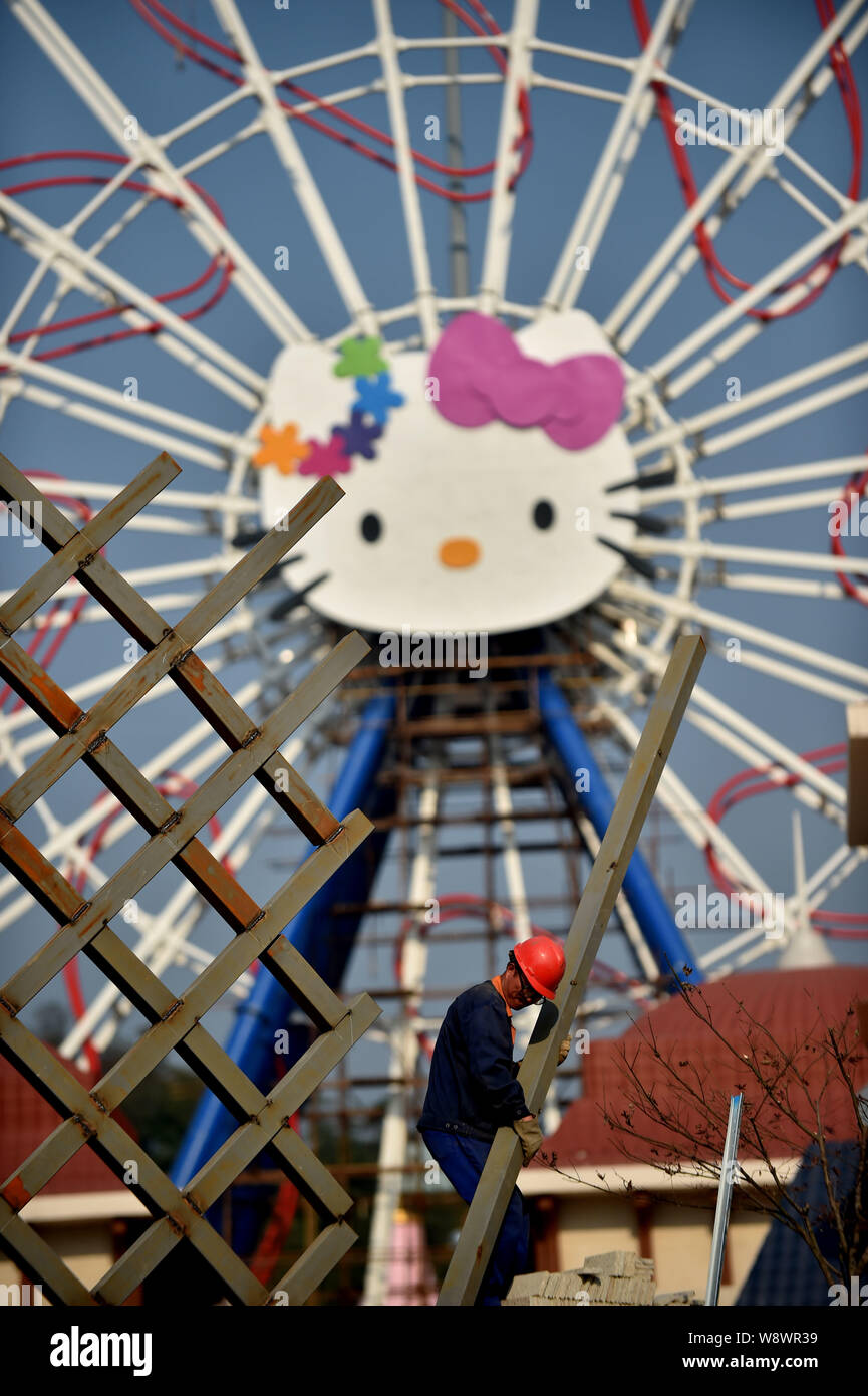 A Chinese worker labors at the Hello Kitty theme park under ...