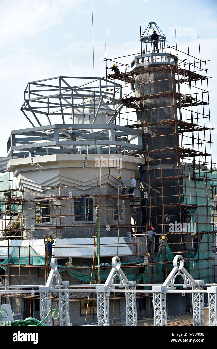 Chinese workers are constructing a building at the Hello Kitty theme ...