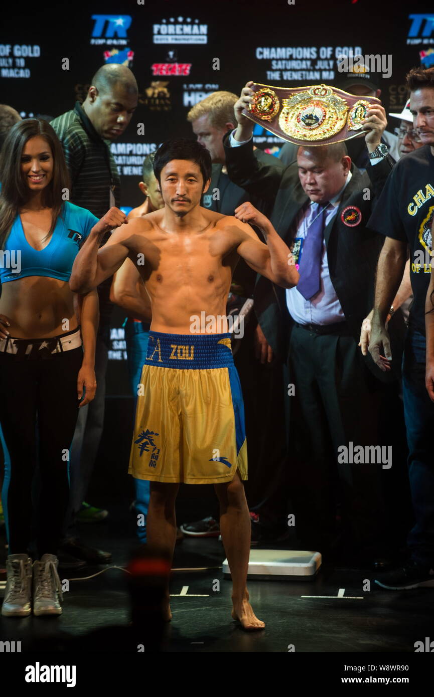 Chinese boxer Zou Shiming, front, poses during the weigh-in for ...