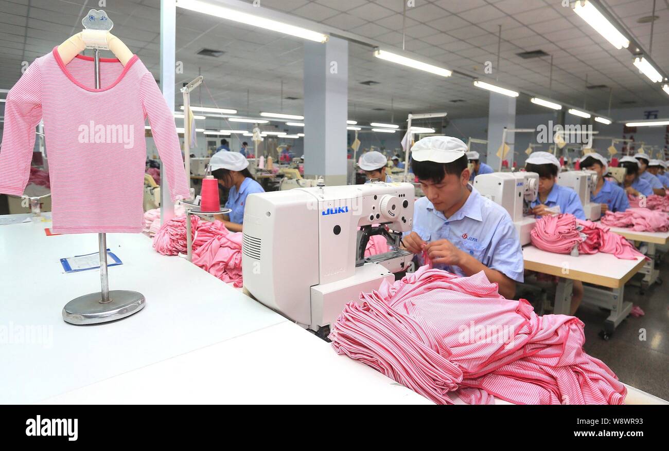 --FILE--Chinese workers sew children¯s garments to be exported at a ...