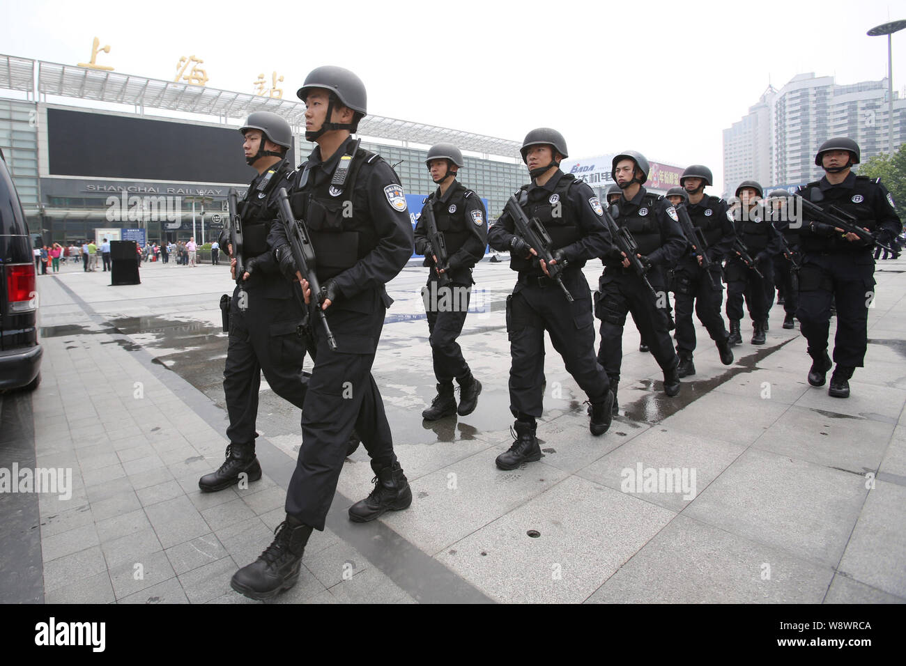 SWAT police officers armed with guns patrol at the square of the ...