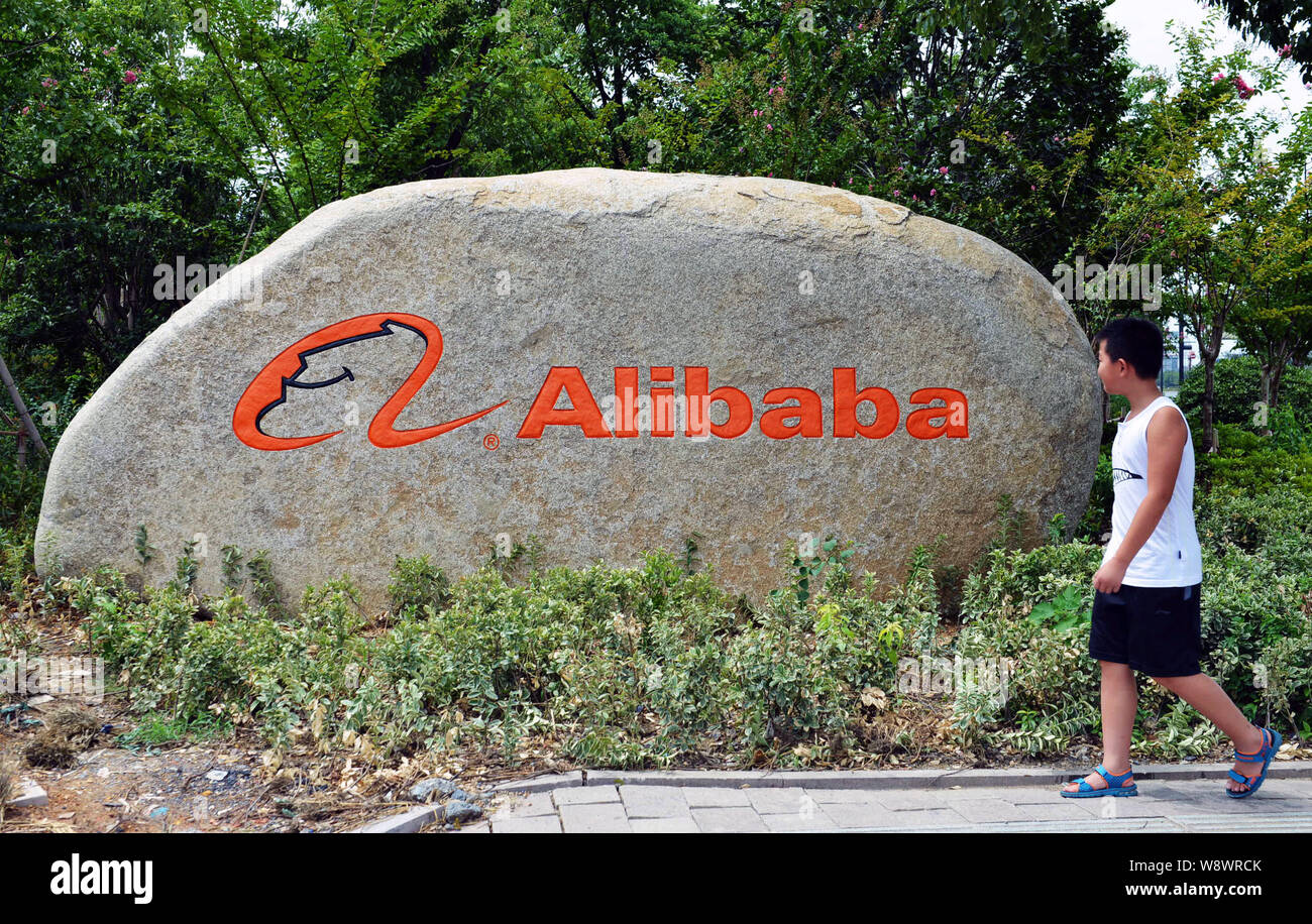 --FILE--A boy walks past the headquarters of Alibaba Group in Hangzhou ...