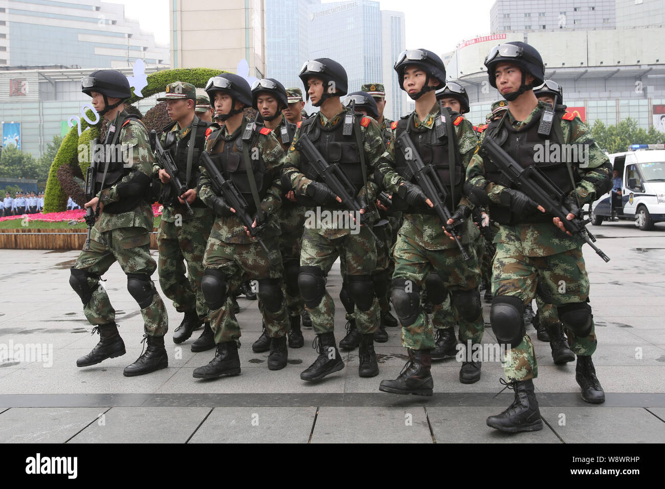 SWAT police officers armed with guns patrol at the square of the ...