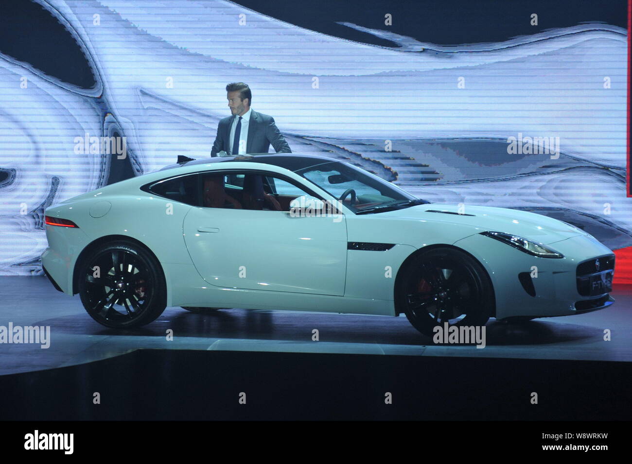 English football superstar David Beckham poses with a Jaguar F-Type ...