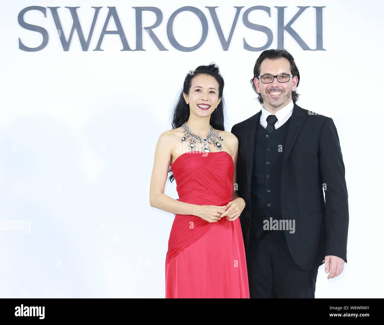 Hong Kong singer and actress Karen Mok, left, poses with an executive ...