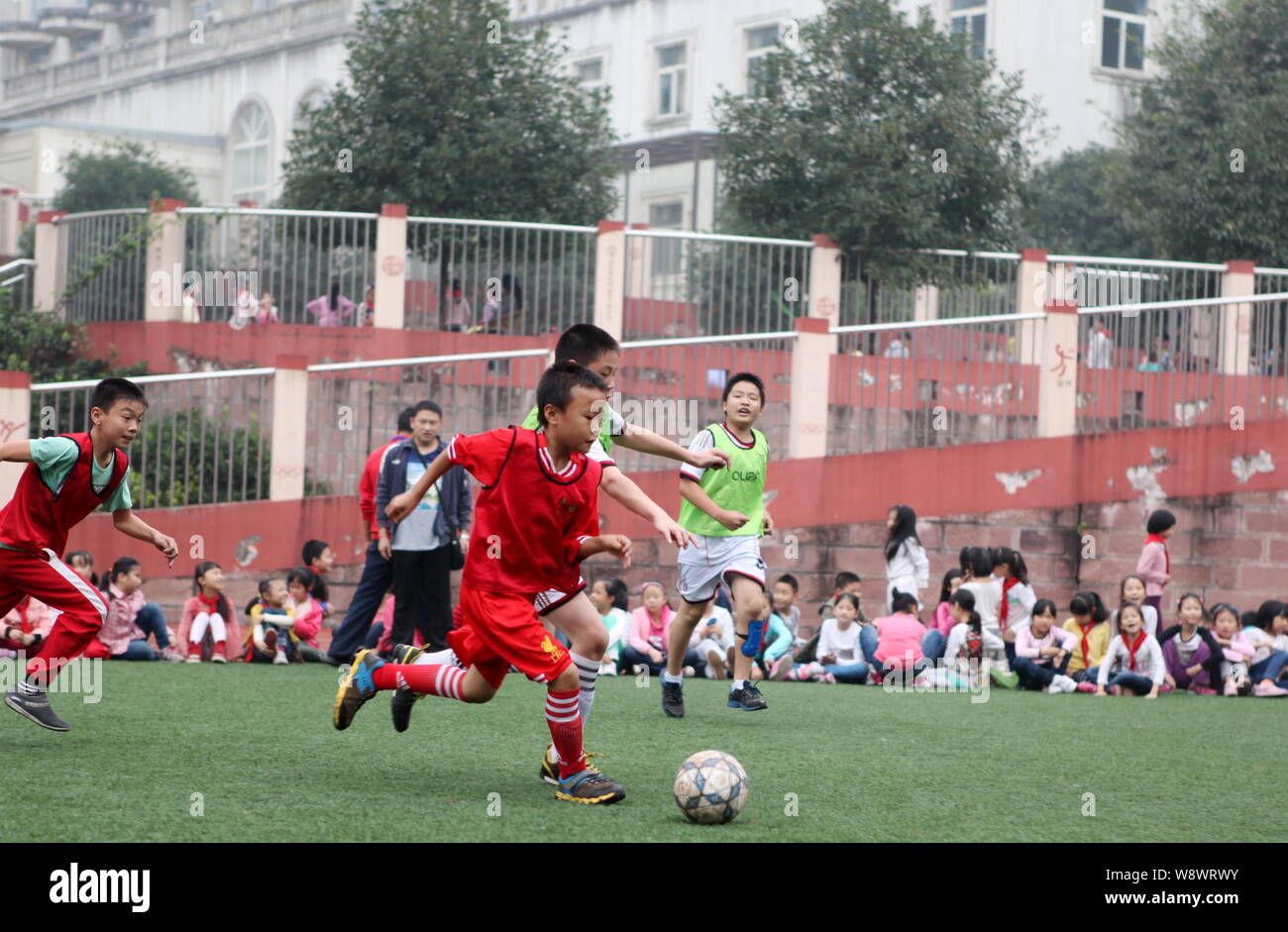--FILE--Young Chinese students compete during a football match at the ...