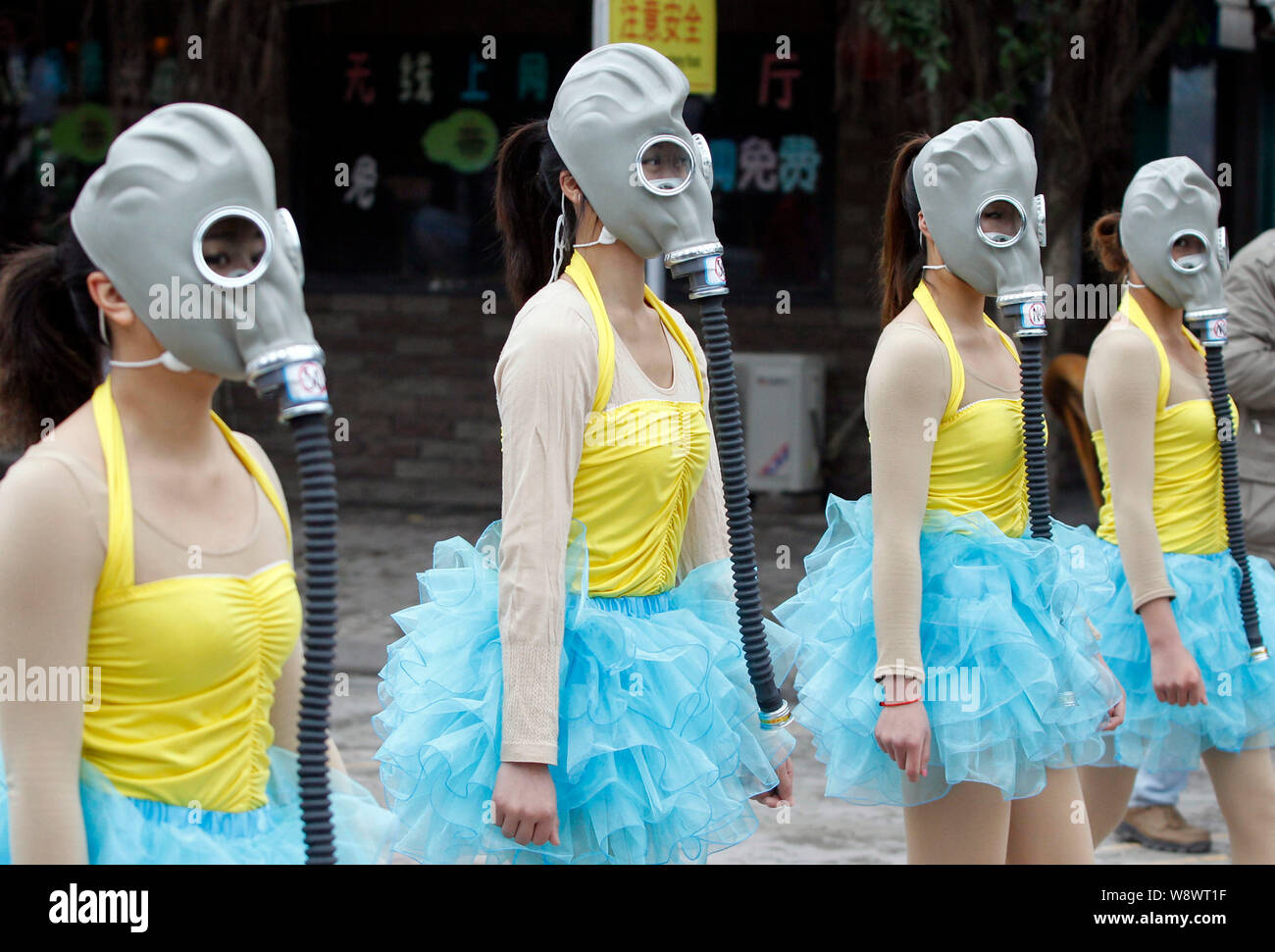 Participants wearing gas masks parade during an anti-smog action art ...