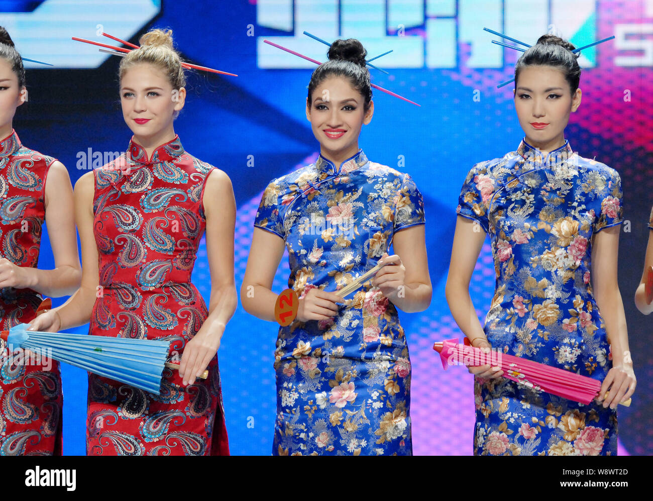 Chinese and foreign models display creations of cheongsam, also known ...