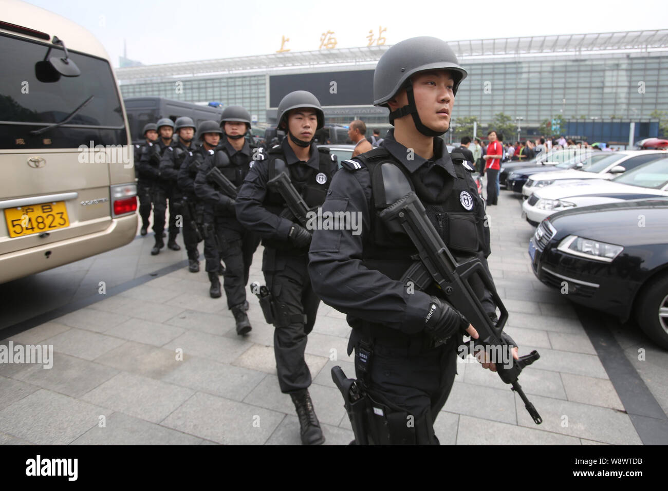 SWAT police officers armed with guns patrol at the square of the ...
