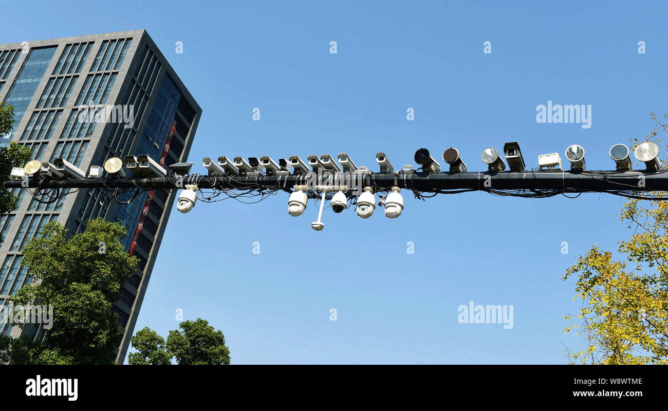 Dozens of surveillance cameras are installed on a beam over a road in ...