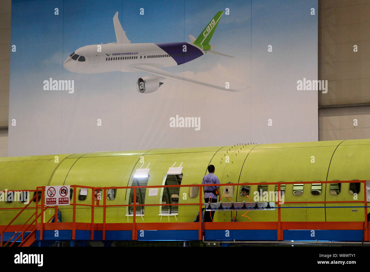 A Chinese technician stands next to the fuselage of China¯s first ...