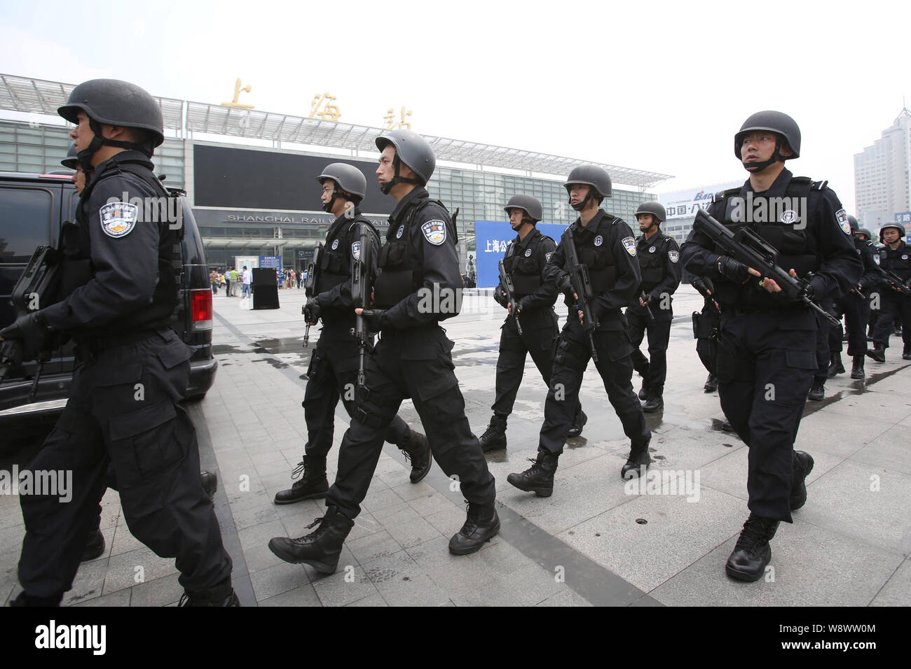 SWAT police officers armed with guns patrol at the square of the ...