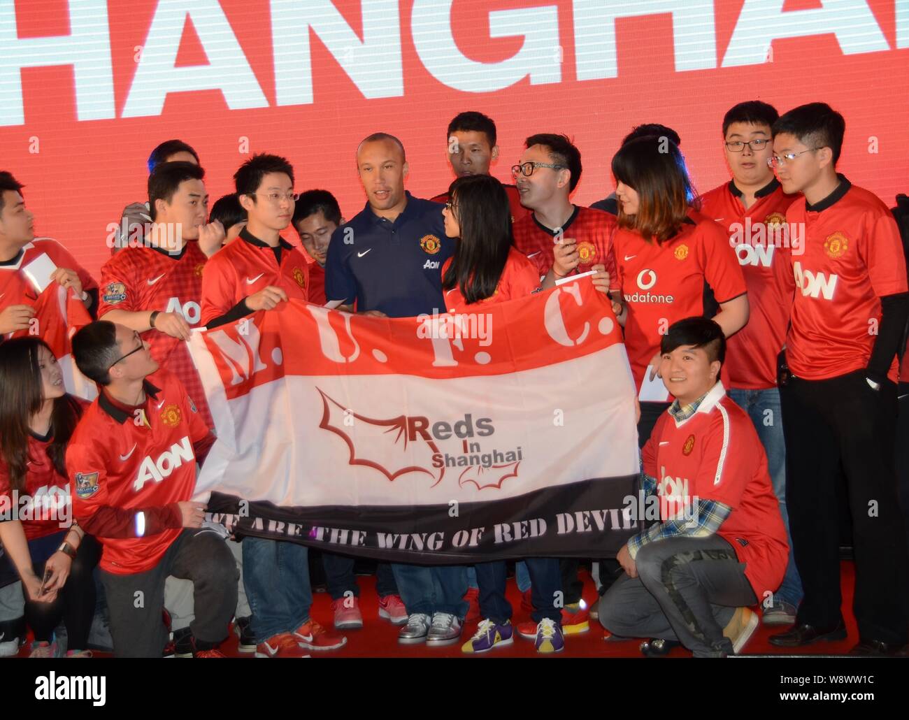 French football player Mikael Silvestre, center, poses for photos with ...