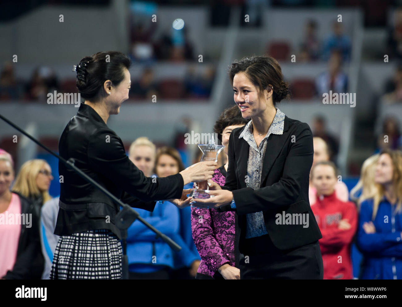 Chinese tennis player Li Na, right, receives an award during her ...