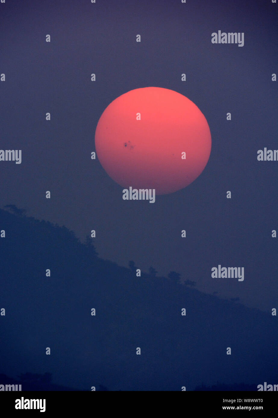 Huge sunspots are seen on the surface of the sun at sunset in Qingdao ...