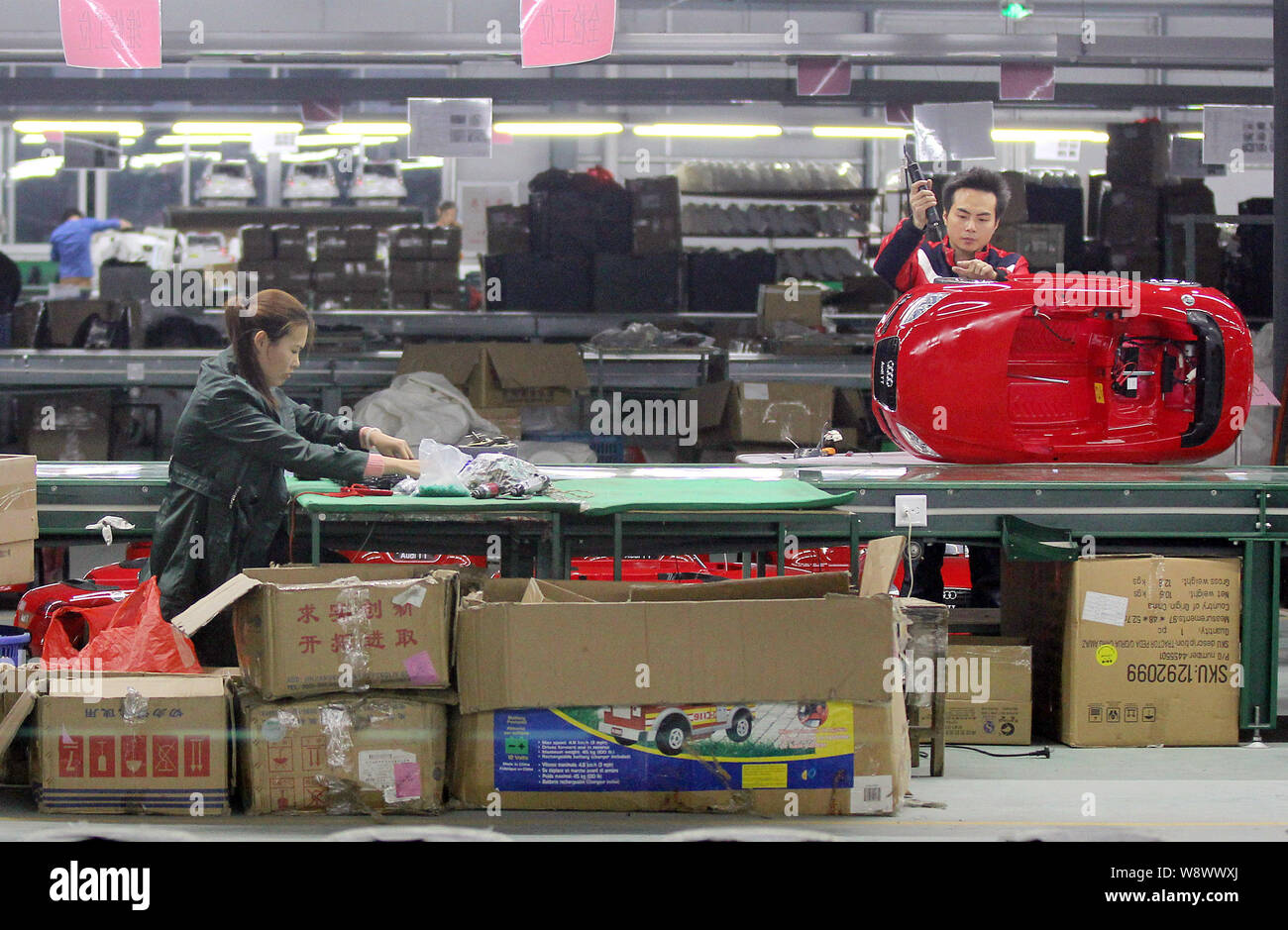--FILE--Chinese workers assemble electric toy cars on the production ...