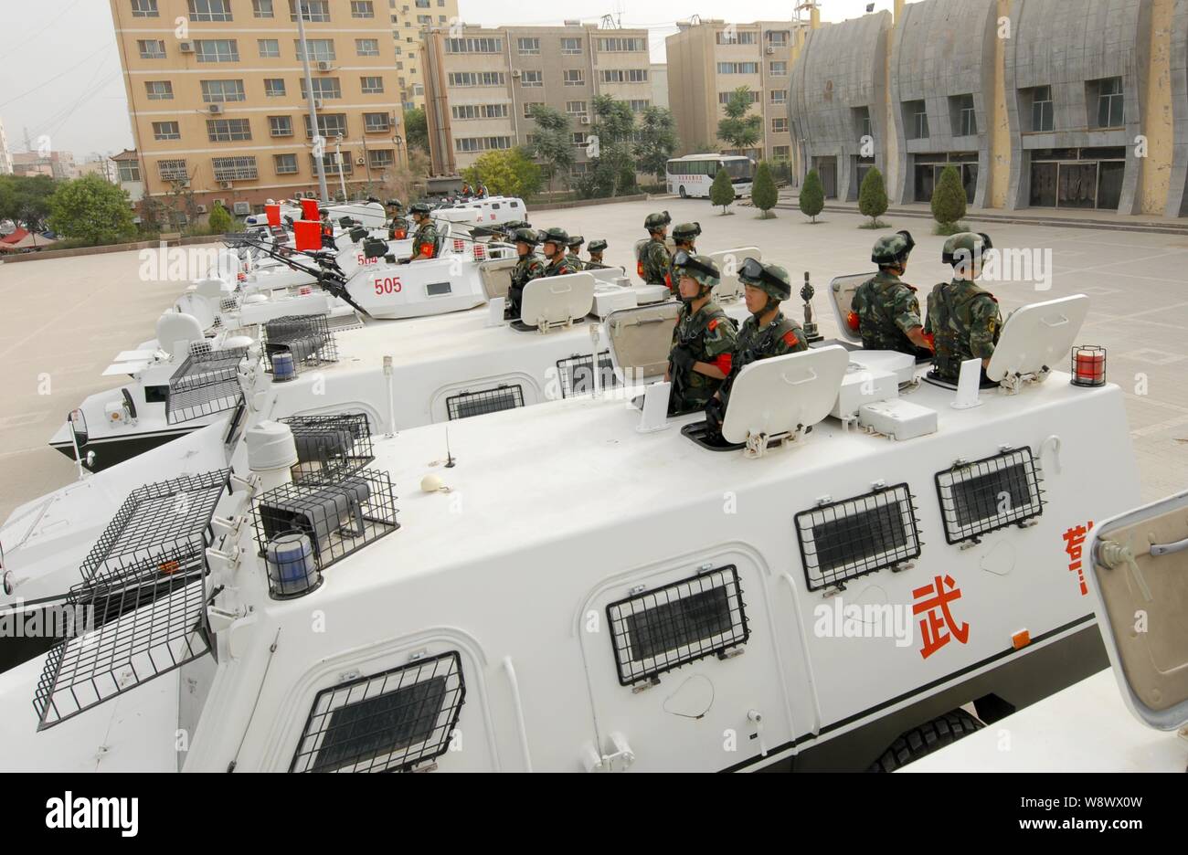 Armed Chinese paramilitary policemen assemble during a city patrol in ...