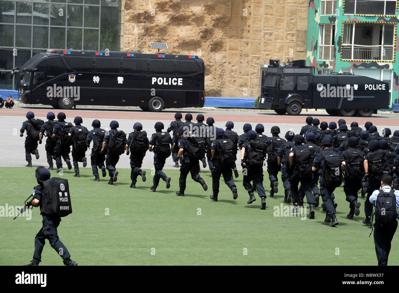 Special police vehicles and SWAT police officers armed with guns ...