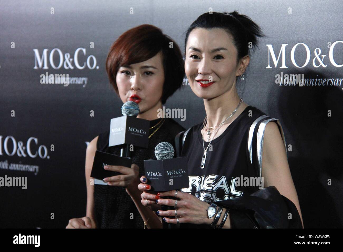 Hong Kong actress Maggie Cheung, right, poses at a fashion event for ...
