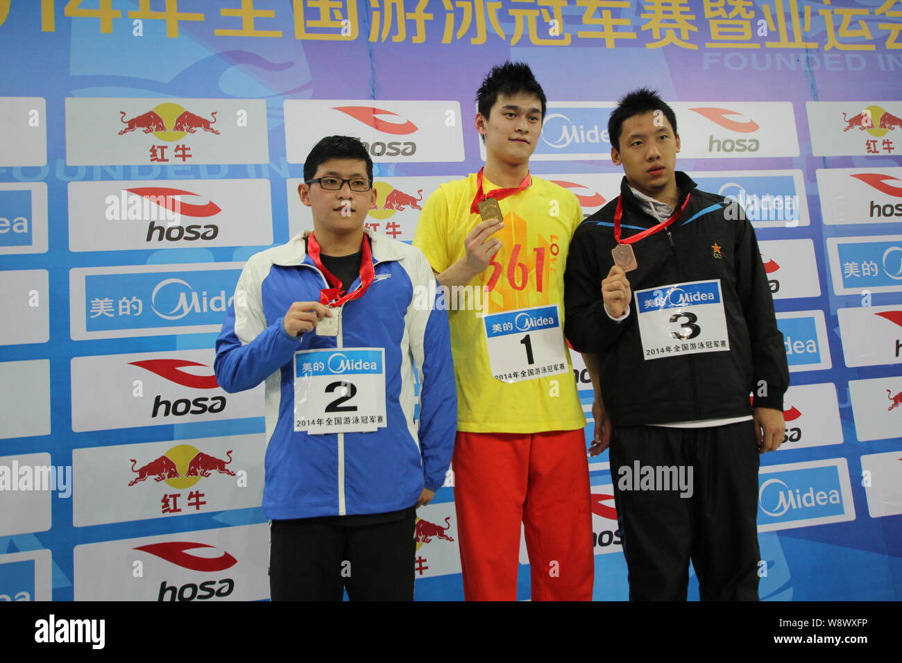 --FILE--Sun Yang of China, center, poses with his gold medal in the ...
