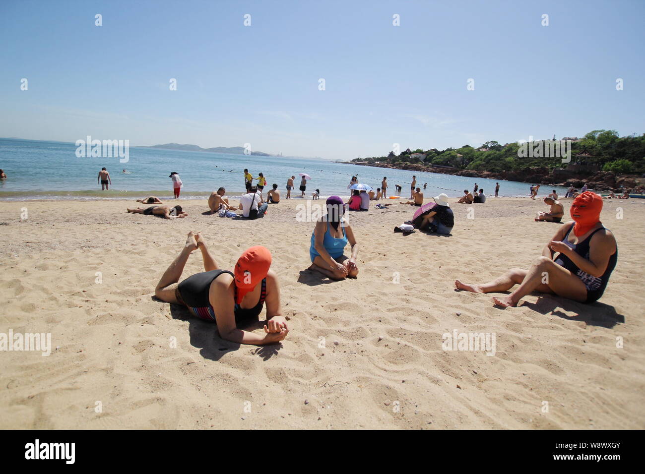 Chinese women wearing masks nicknamed facekinis enjoy sun bath at a ...