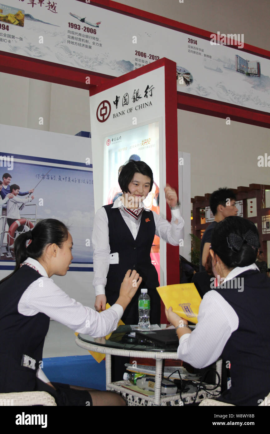 --FILE--Chinese employees are seen at the stand of Bank of China (BOC ...