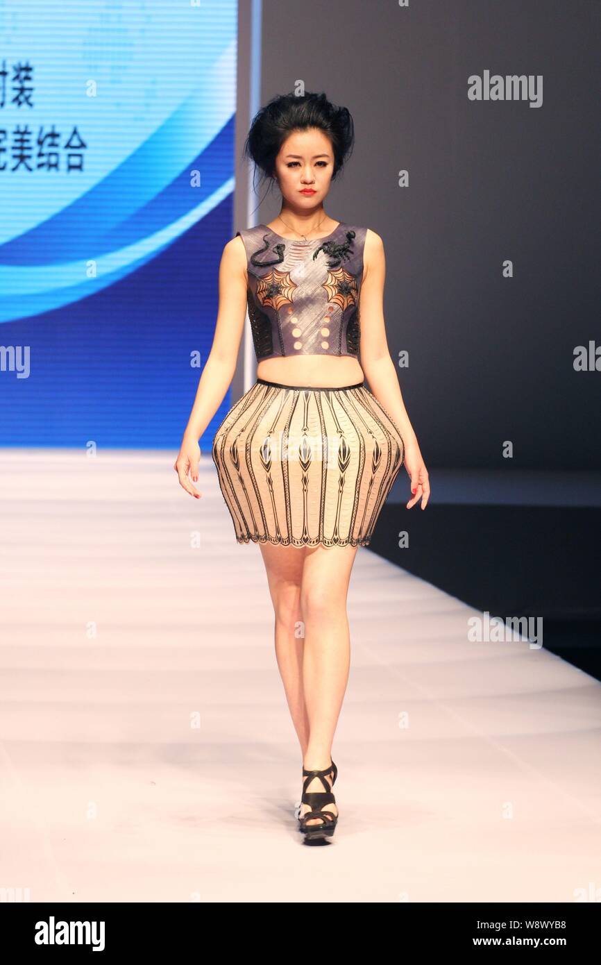 A model displays a new creation made by 3D printers at a fashion show ...