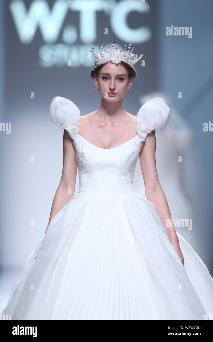 A model displays a new creation at the fashion show of Disney Princess ...