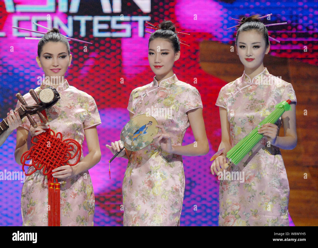 Chinese model Huo Jialin, right, and foreign models display creations ...