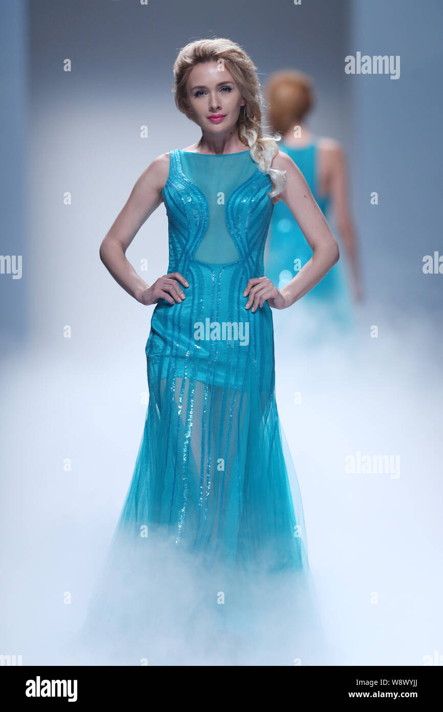 A model displays a new creation at the fashion show of Disney Princess ...