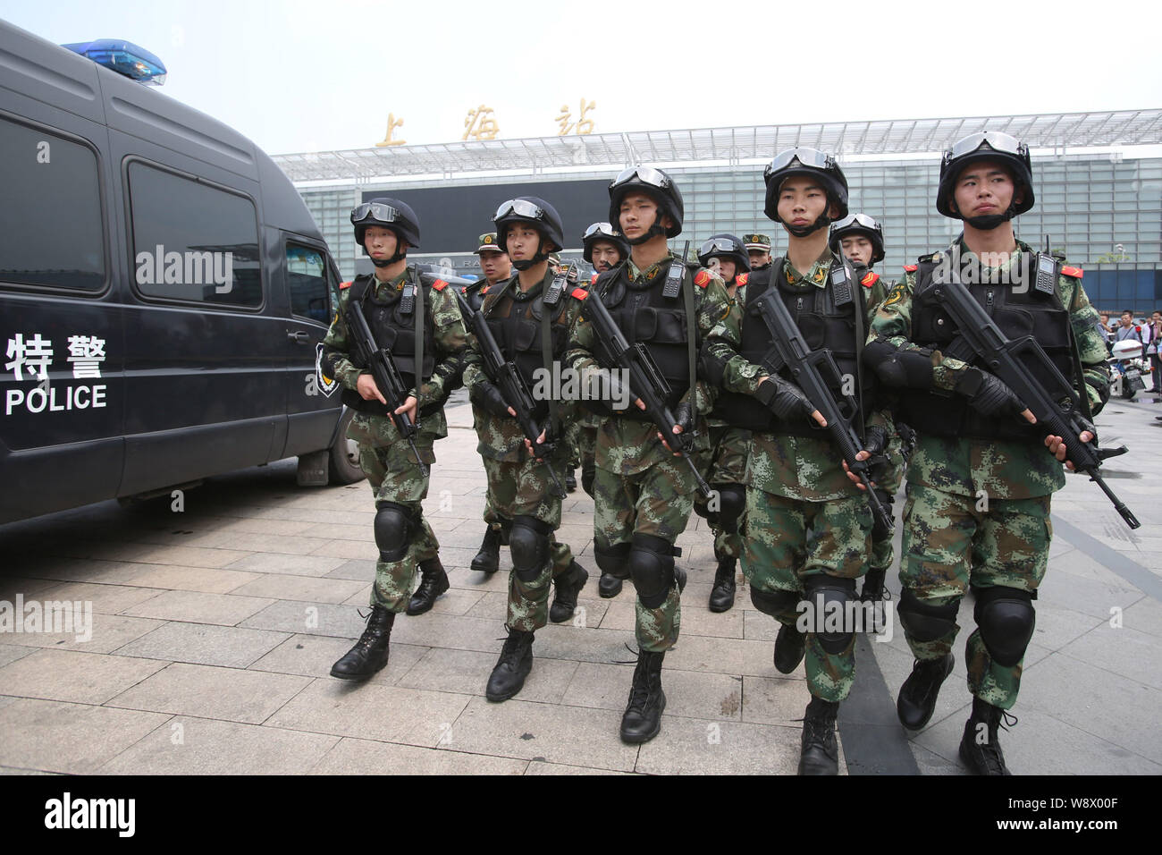 SWAT police officers armed with guns patrol at the square of the ...