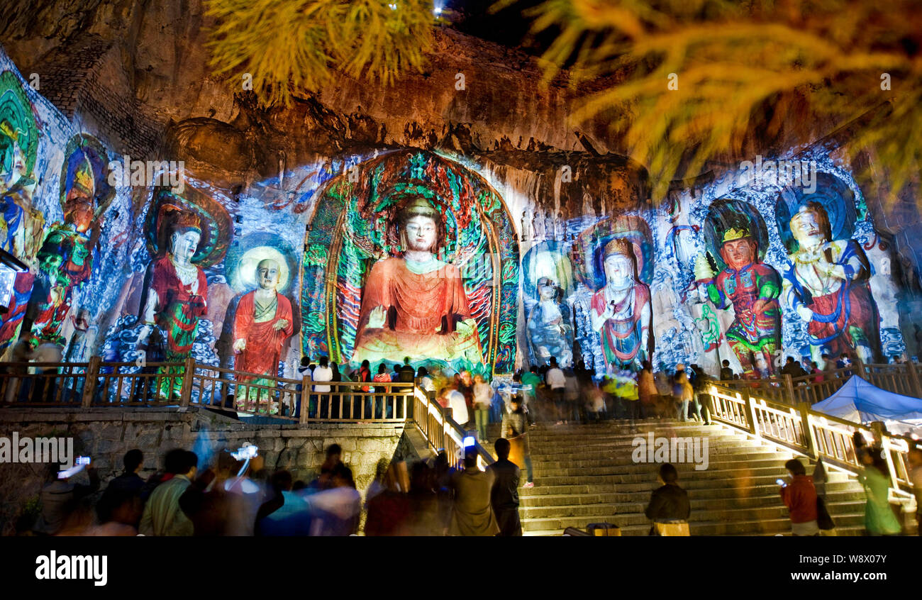 Night view of frescos of the Longmen Grottoes in Luoyang city, central ...
