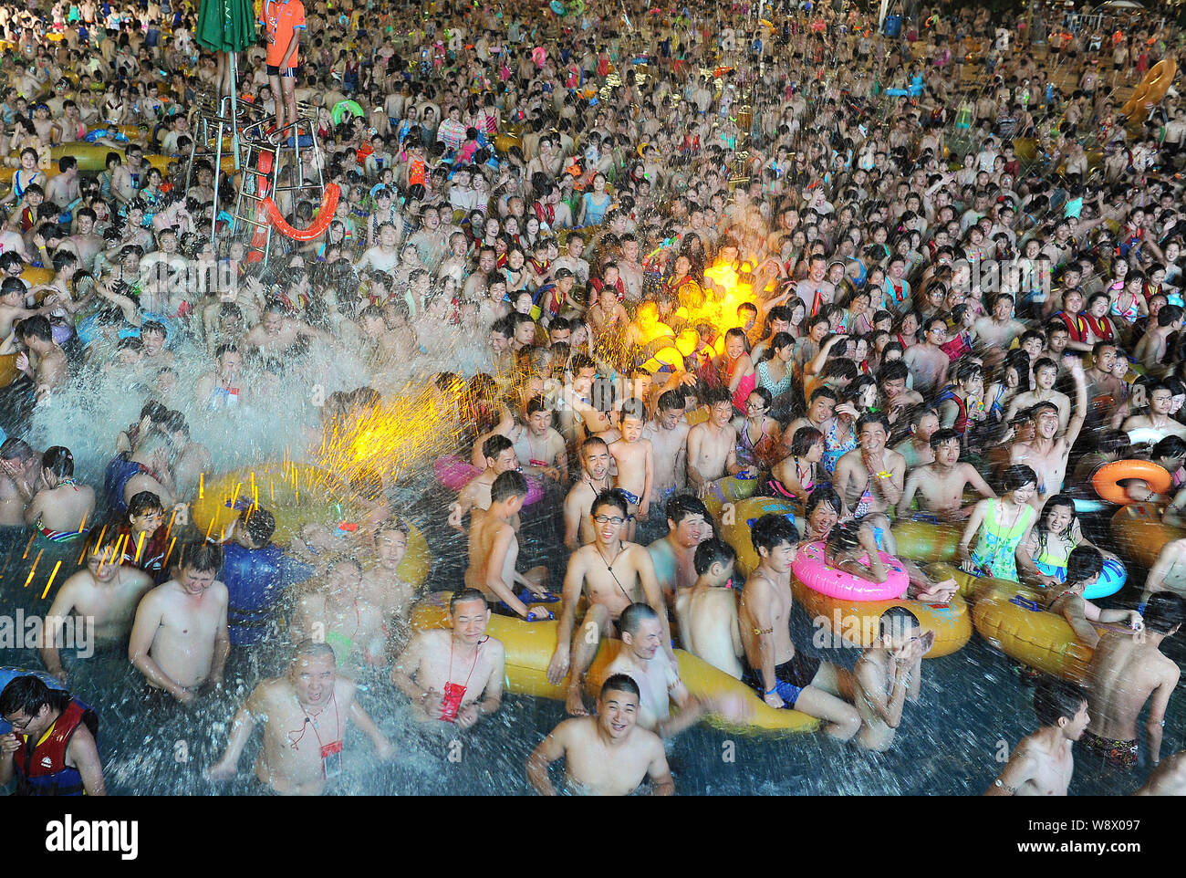 Holidaymakers overcrowd a swiming pool to cool off at the Playa Maya ...