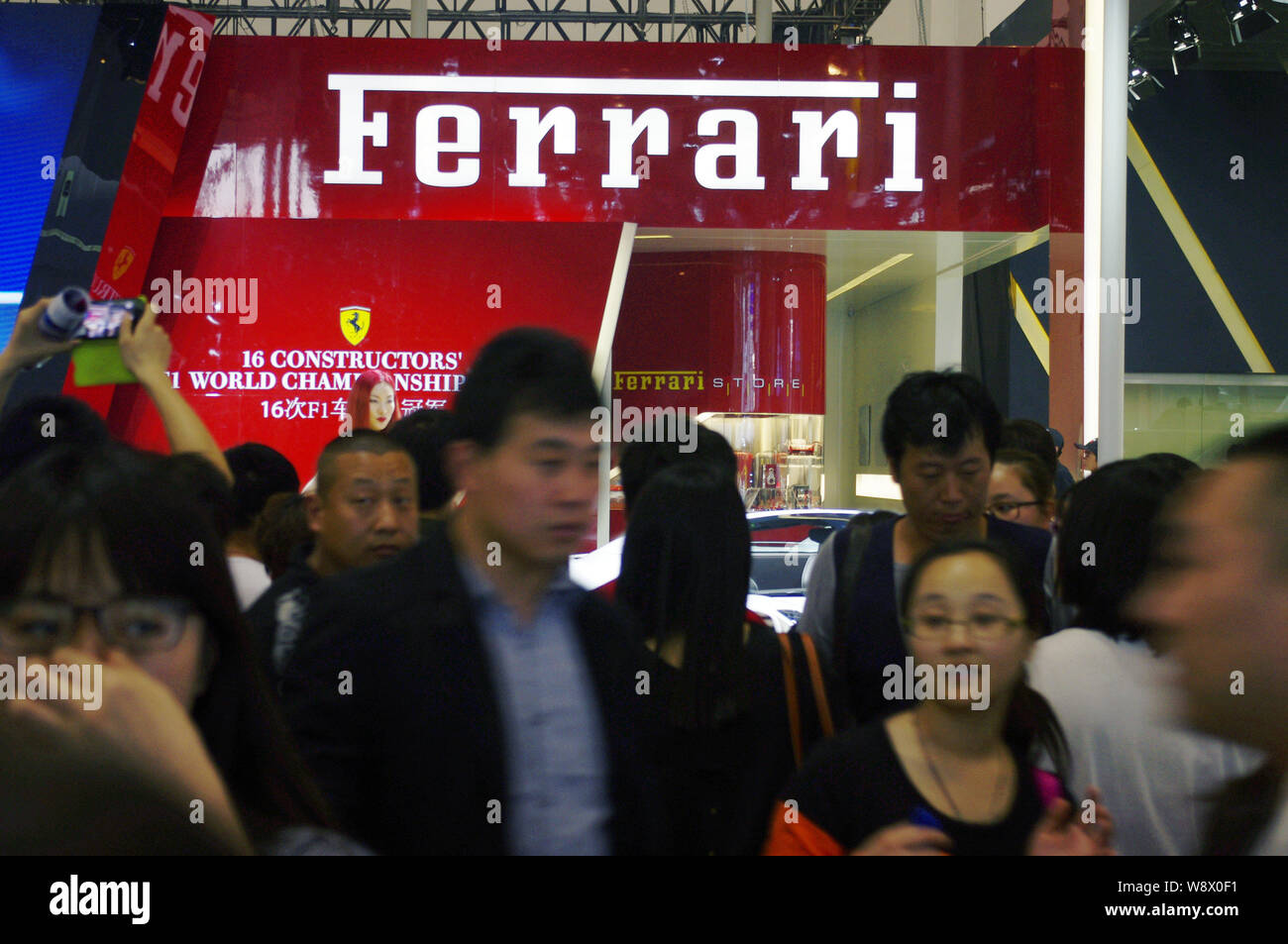 Visitors crowd the stand of Ferrari during the 13th Beijing ...