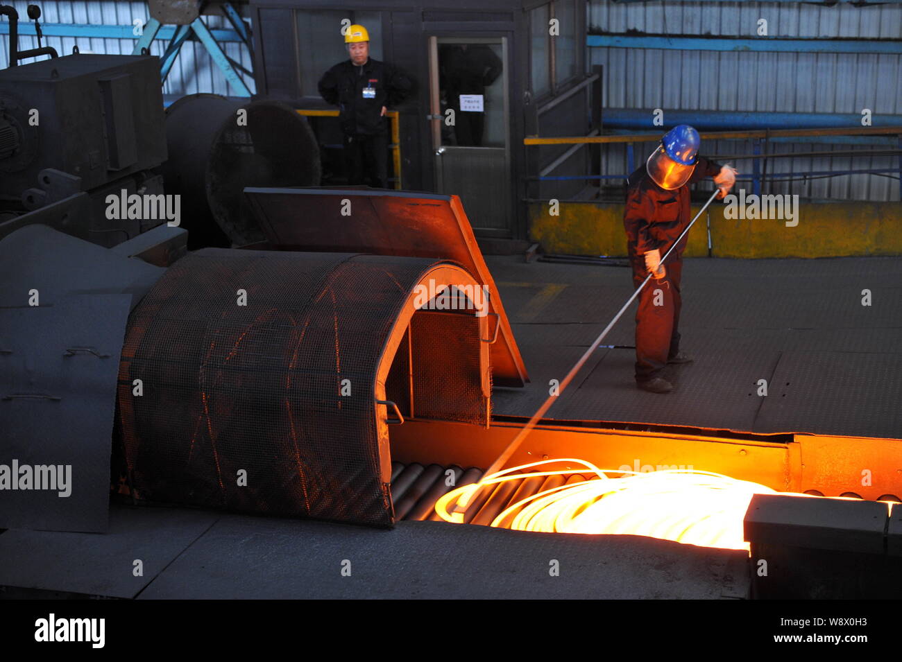 --FILE--A Chinese worker produces steel at a plant of Rizhao Steel ...
