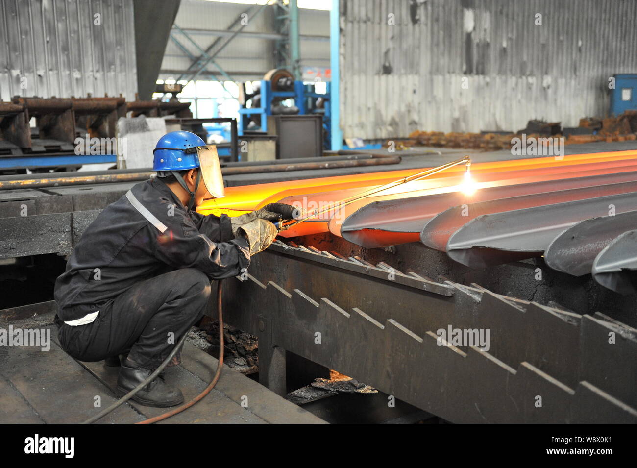 --FILE--A Chinese worker produces steel at a plant of Rizhao Steel ...