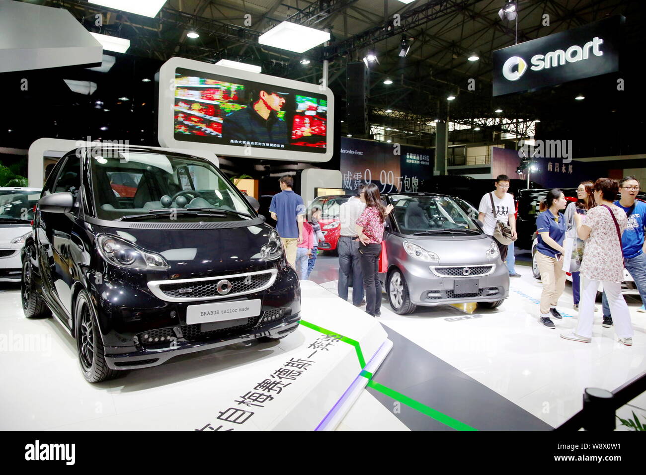 --FILE--Visitors look at Smart compact cars of Mercedes-Benz on display ...