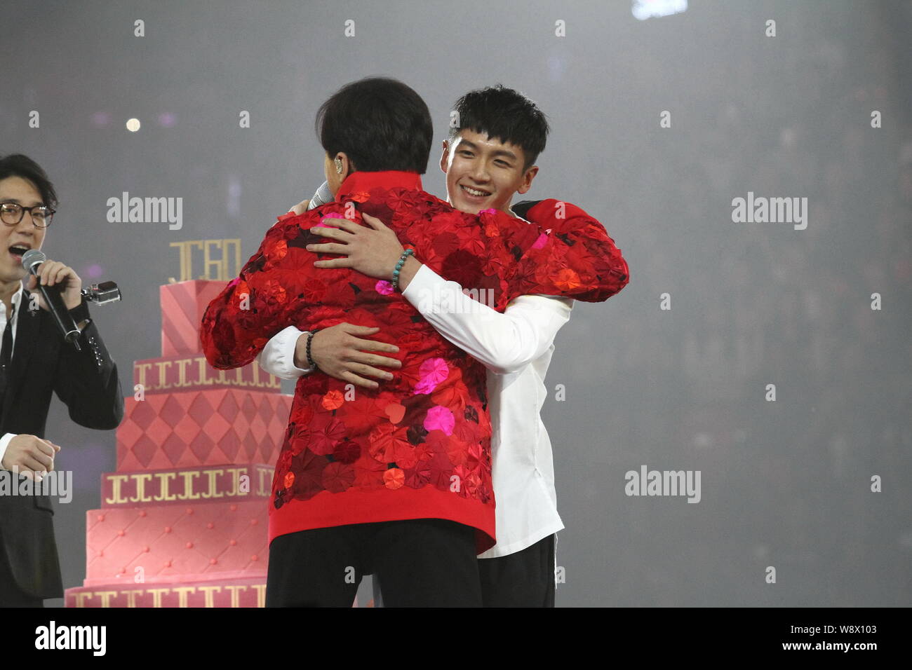 Hong Kong actor Jackie Chan, front, hugs Taiwanese actor Kai Ko during ...